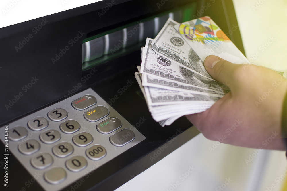 Hand of a man with a credit card, using an ATM. Man using an atm ...
