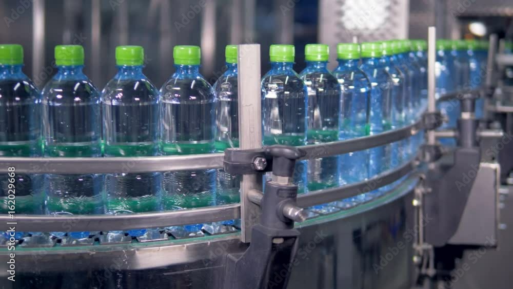 Steady moving production line of water bottles. Stock Video | Adobe Stock