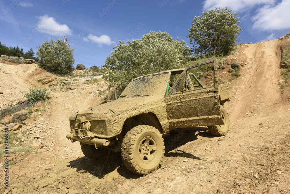 Muddy off-road car after it was pulled out of the mud on an adventurous ...