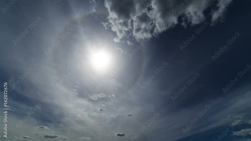 Stockvideon Sun with halo corona rainbow and nature cloudscape with blue sky and white cloud ...