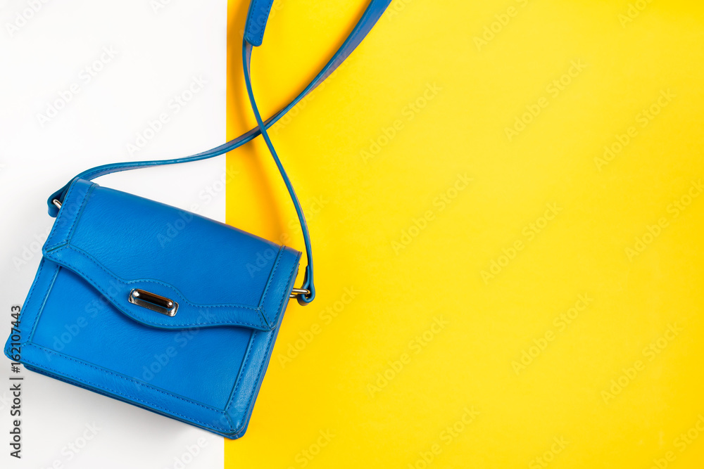 Woman purse on colorful background. Blue and yellow pastel colors, top ...