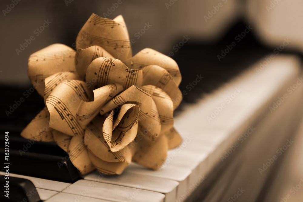 Rose made of music notes on piano keys Stock Photo | Adobe Stock