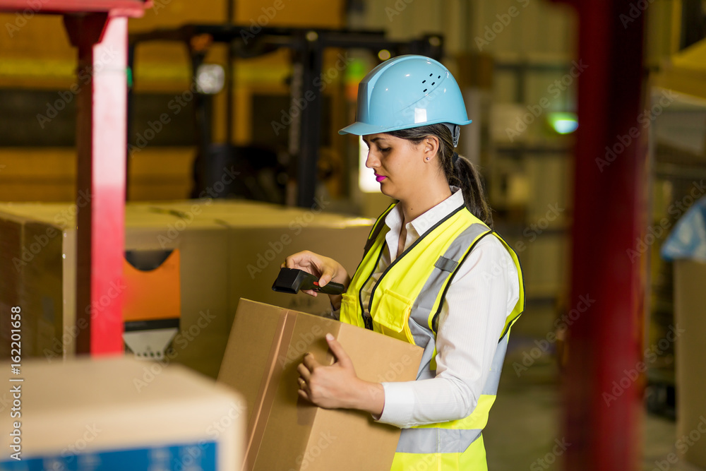 female warehouse worker checking delivering boxes. distribution center ...