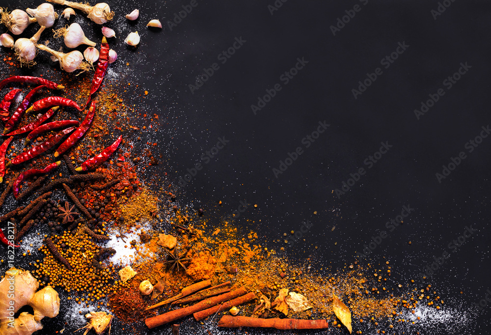 Variety Spices and herbs on black stone background, Top view with empty ...