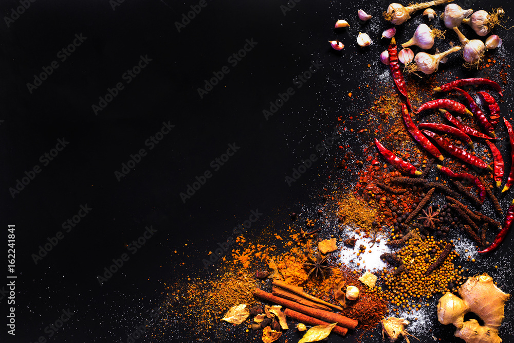 Variety Spices and herbs on black stone background, Top view with empty ...