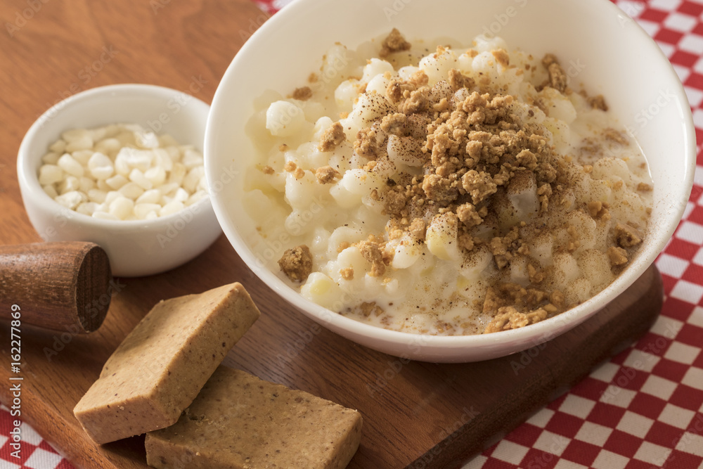 Brazilian dessert sweet canjica of white corn with pacoca sweet in bowl ...