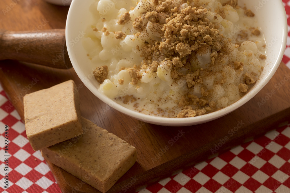 Brazilian dessert sweet canjica of white corn with pacoca sweet in bowl ...