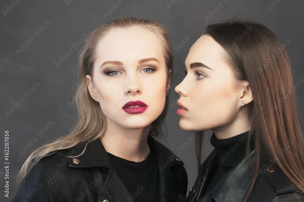 Two girls are pressed against each other. Stock Photo | Adobe Stock