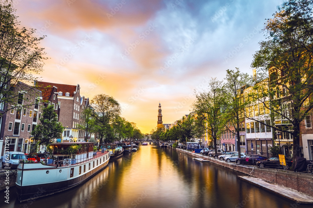 The most famous canals and embankments of Amsterdam city during sunset ...