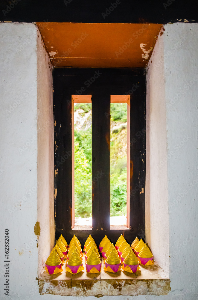 Old asian window from inside with tsha tshas (devotional objects of ...