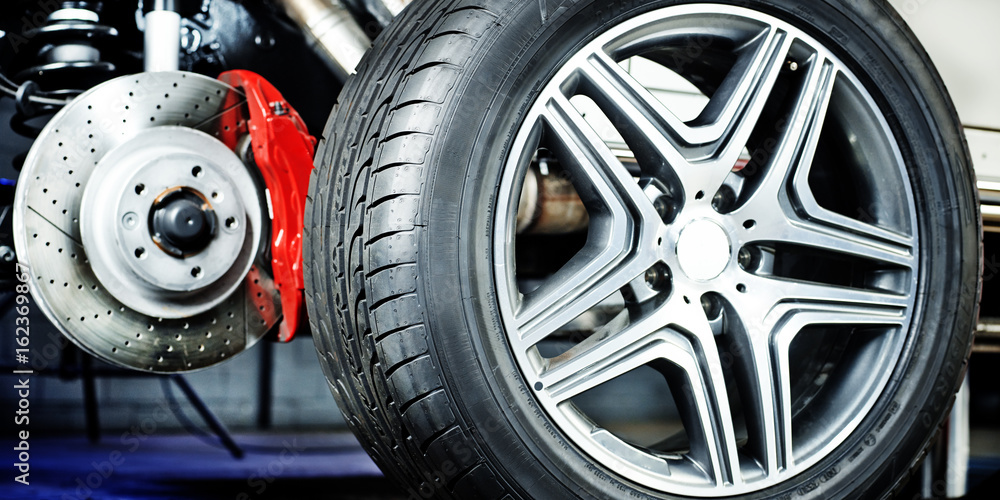 Changing a tyre in a garage Stock Photo | Adobe Stock
