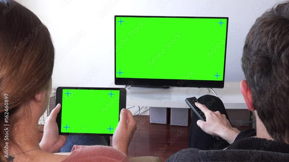 Zoom In Couple Watching Green Screen Television And Tablet. Couple ...