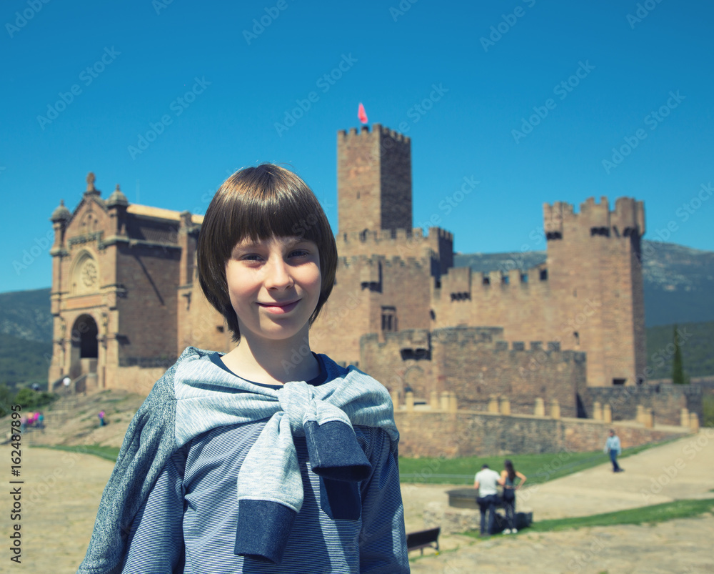 Fotka „Young boy posing and smiling over ancient spanish castle Javier ...
