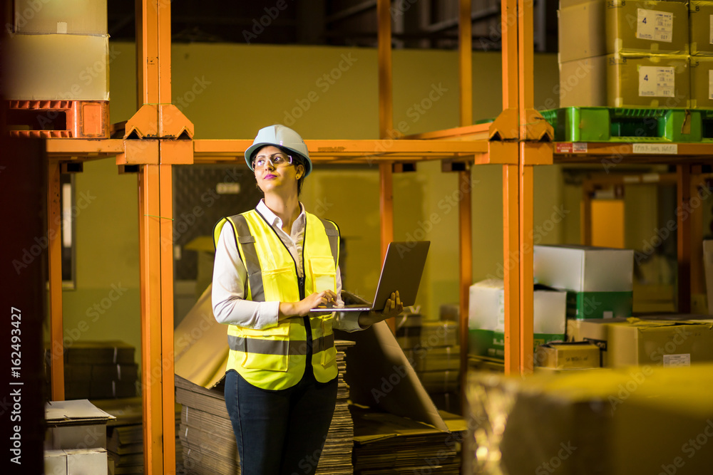 female warehouse worker checking delivering boxes. distribution center ...