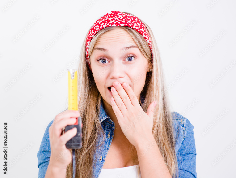 Woman shocked by the size of the measuring tape Stock Photo | Adobe Stock