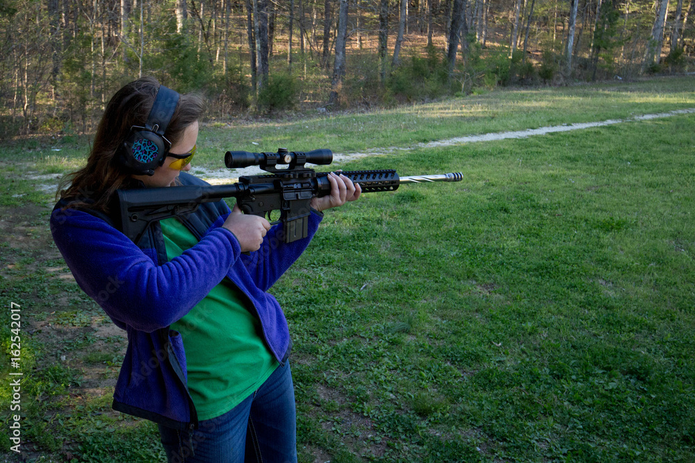 Teenage girl at shooting range Stock Photo | Adobe Stock