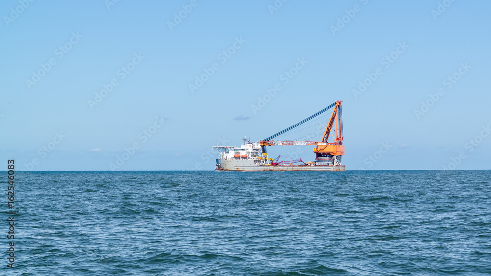 Heavy lift ship with crane sailing on North Sea leaving port of ...