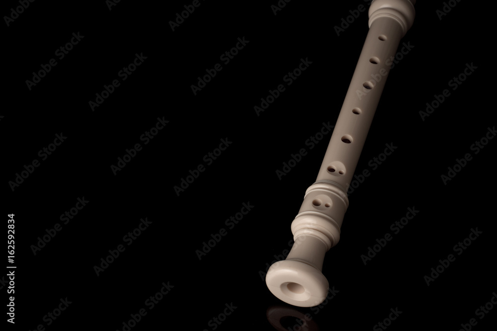 classical musical instrument is the block flute on black background ...
