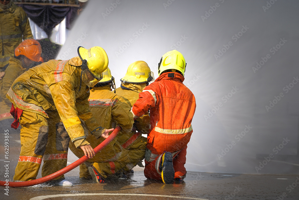 Fireman. Firefighters fighting fire during training. Stock Photo ...