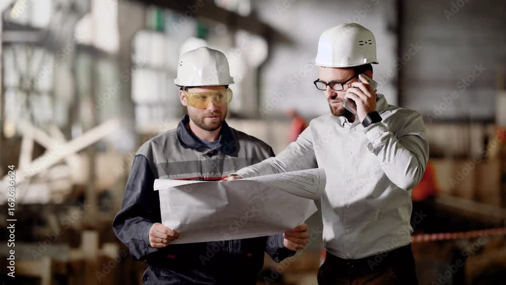 Workers on building construction. Supervisor of construction talking ...