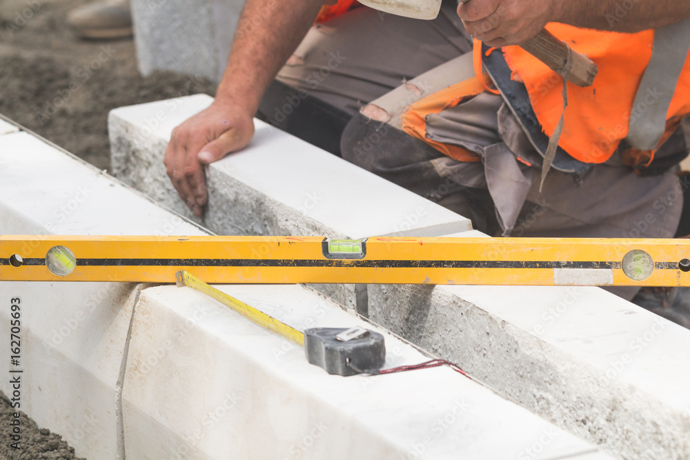 Construction worker leveling concrete pavement outdoors. Stock Photo ...