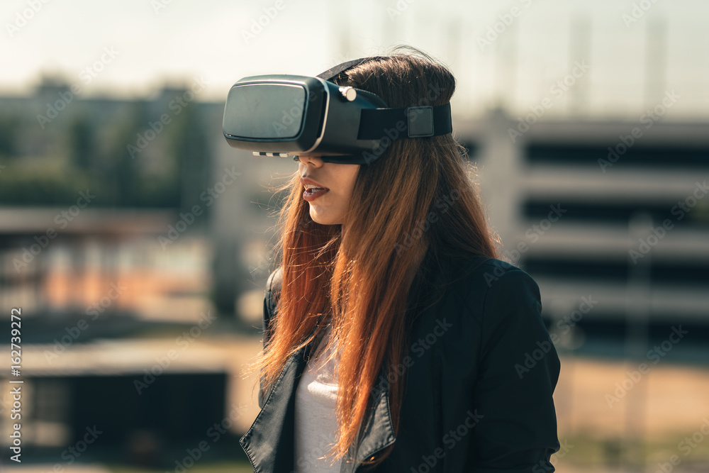 Young gamer girl using the new VR system, happy to reenact her favorite ...