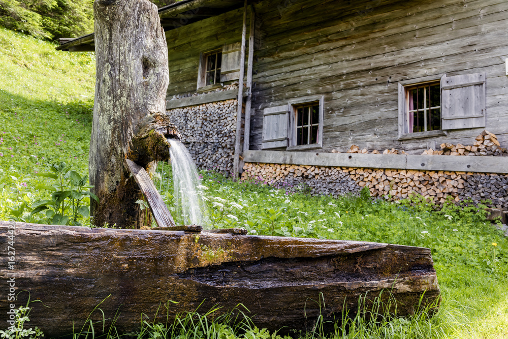 Brunnen auf einer Alm in den Tiroler Alpen Stock Photo | Adobe Stock