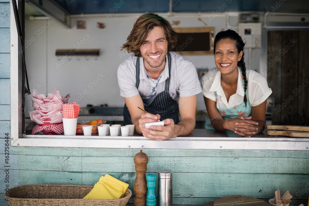 Portrait of waiter and waitress smiling Stock Photo | Adobe Stock