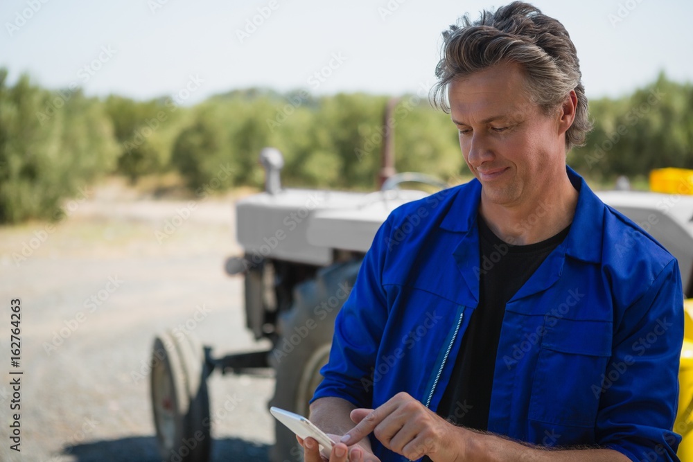 Worker using mobile phone on a sunny day Stock Photo | Adobe Stock