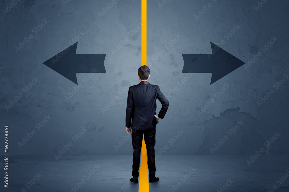 Business person choosing between two options separated by a yellow ...