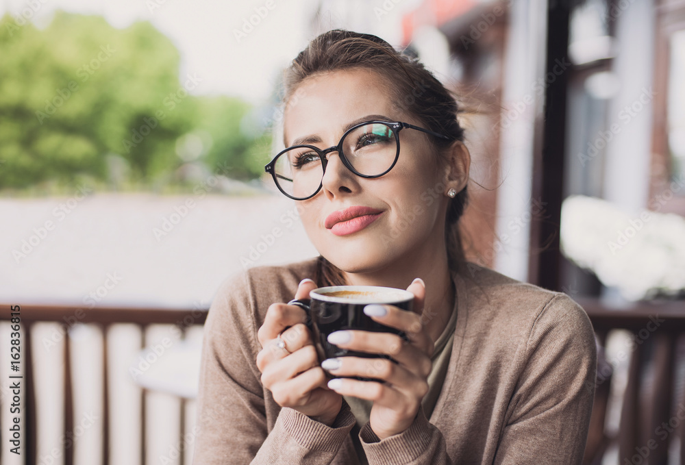 Beautiful young woman drinking coffee in a cafe. Relaxation, coffee ...
