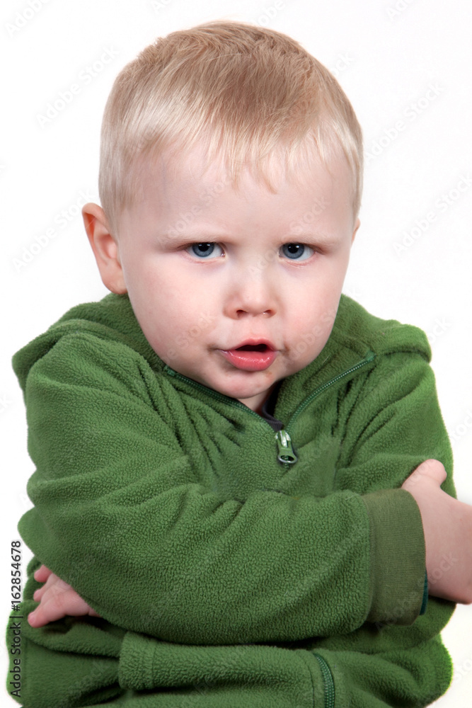 Little child with chubby cheeks looking defiant and upset. Stock Photo ...