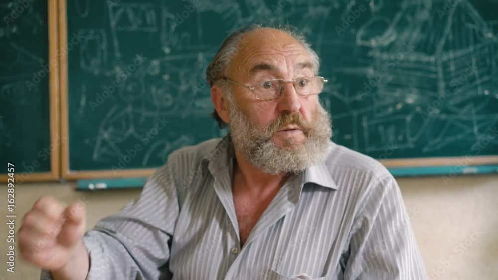 An angry old teacher shouts with emotions to the pupils 4K Stock ビデオ ...