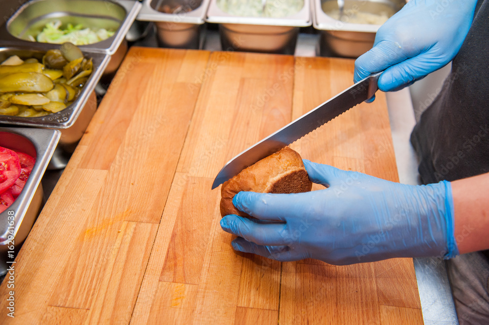 Chief cook preparing fresh burger in the kitchen.Burger restaurant menu ...