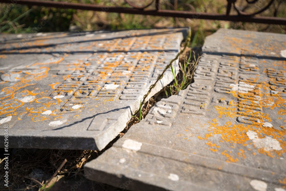 Broken gravestone, symbol for the fragility and transience of life ...