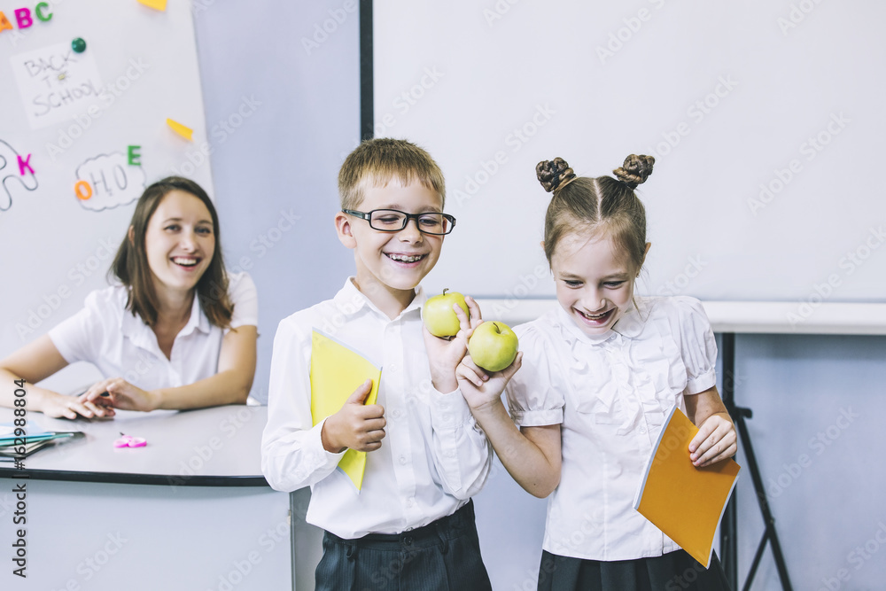 Beautiful children are students together in a classroom in school get ...