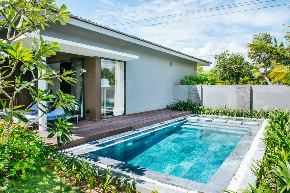 Tropical beach resort. Swimming pool near living room Stock Photo ...