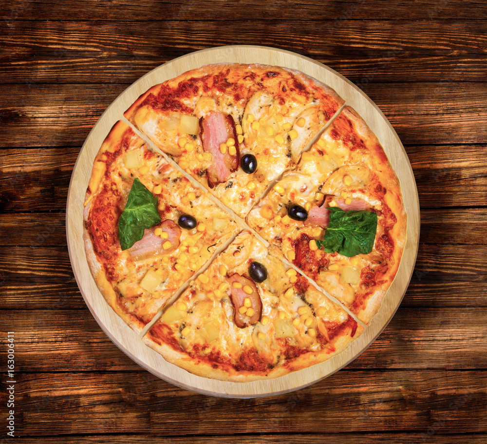 Pizza Hawaii on the wooden table.This picture is perfect to design your ...