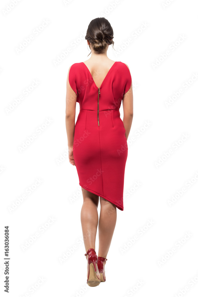 Rear view of elegant woman with bun hairstyle in red evening dress ...