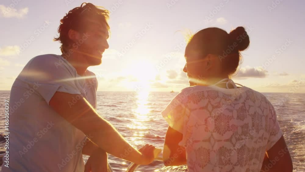 Cruise ship - Romantic couple enjoying sunset over the ocean on small ...