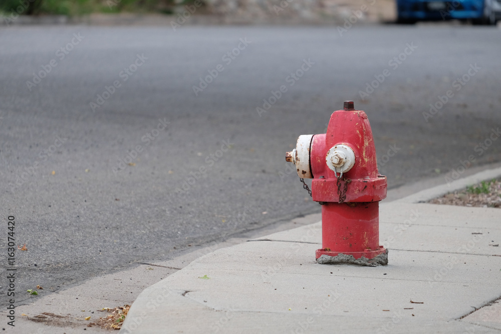 Red and white rusting fire hydrant on street corner Stock Photo | Adobe ...