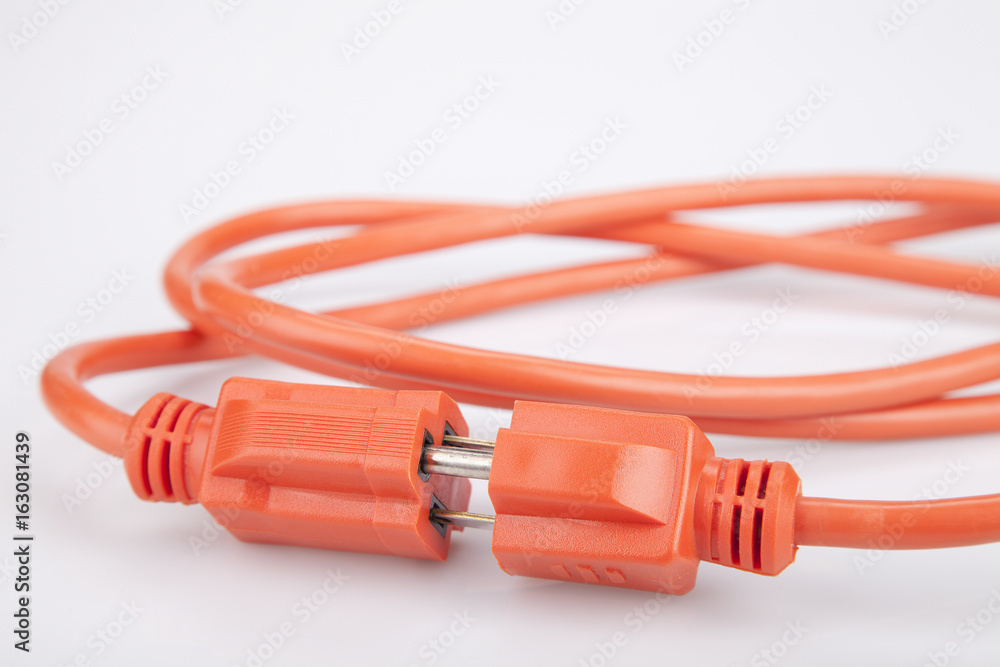 Bright orange extension cord on a white surface. Orange extension cable ...