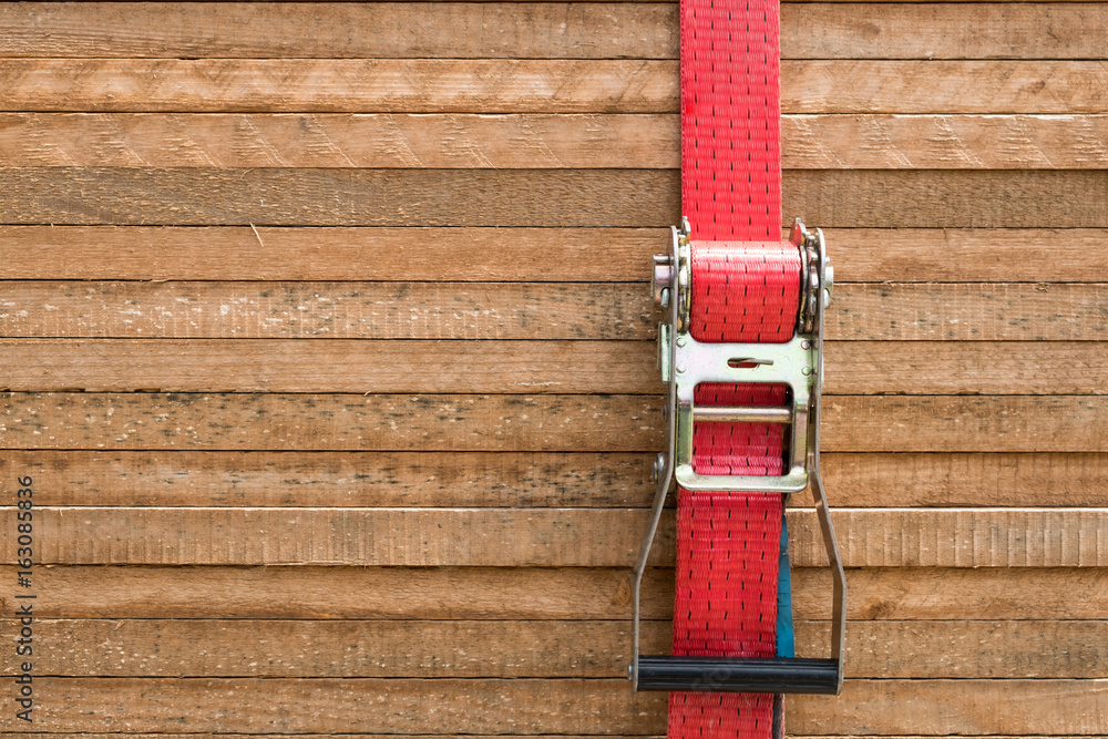 red ratchet strap fixing wood boards / wooden planks Stock Photo ...