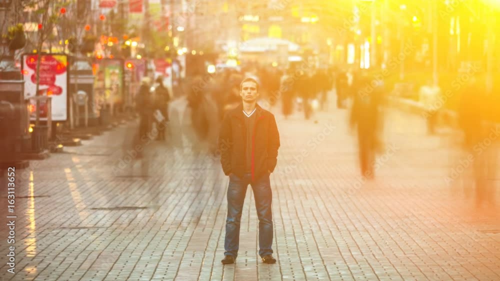 Man stand in ghost crowd stream. sunset on sunrise light flare seen ...