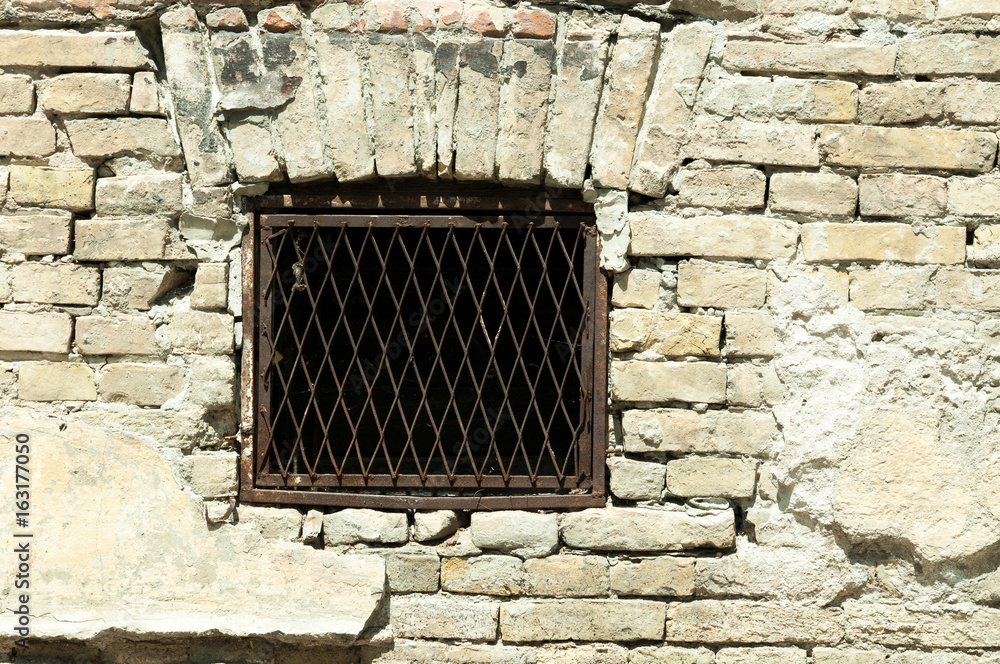 Basement window with rusty iron bars on old abandoned brick house ...