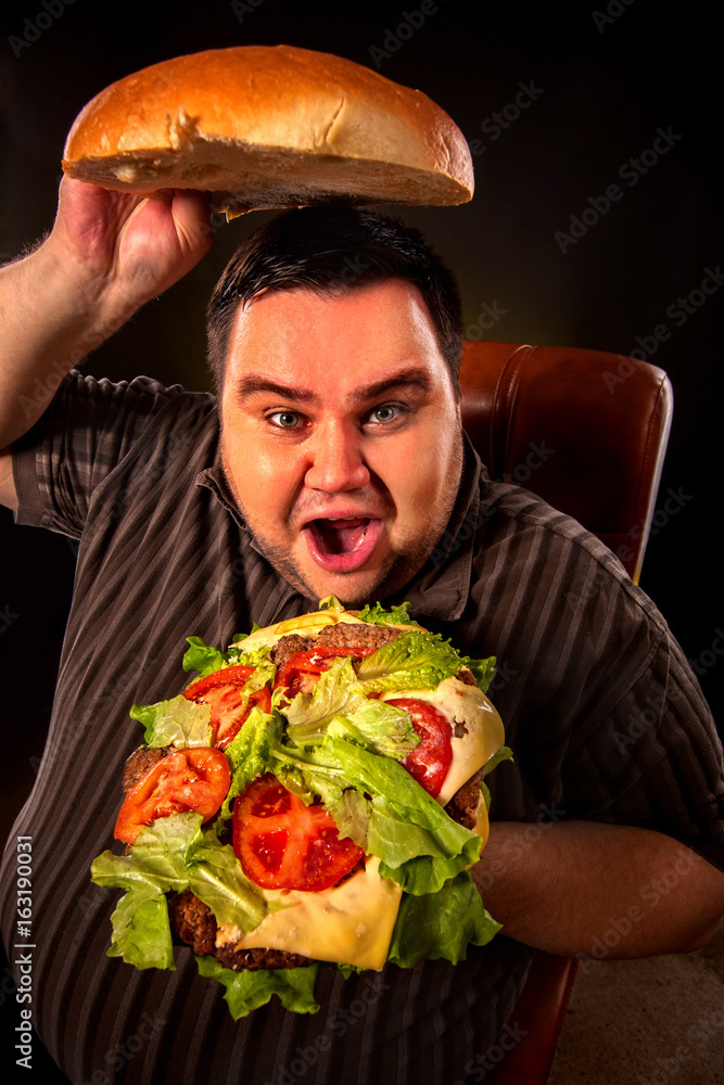 Diet failure of fat man eating fast food hamberger. Overweight person ...