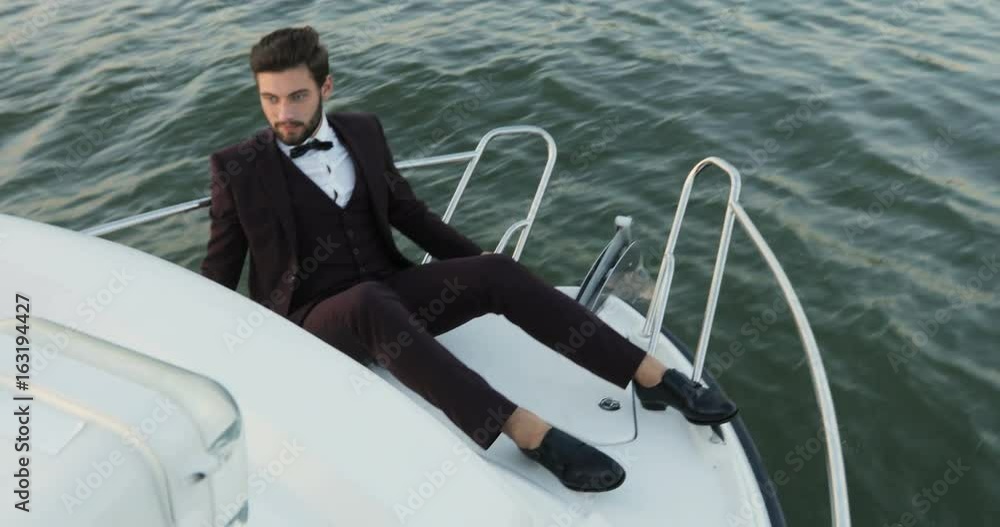 Stylish businessman on a yacht or boat against a sea. transport ...