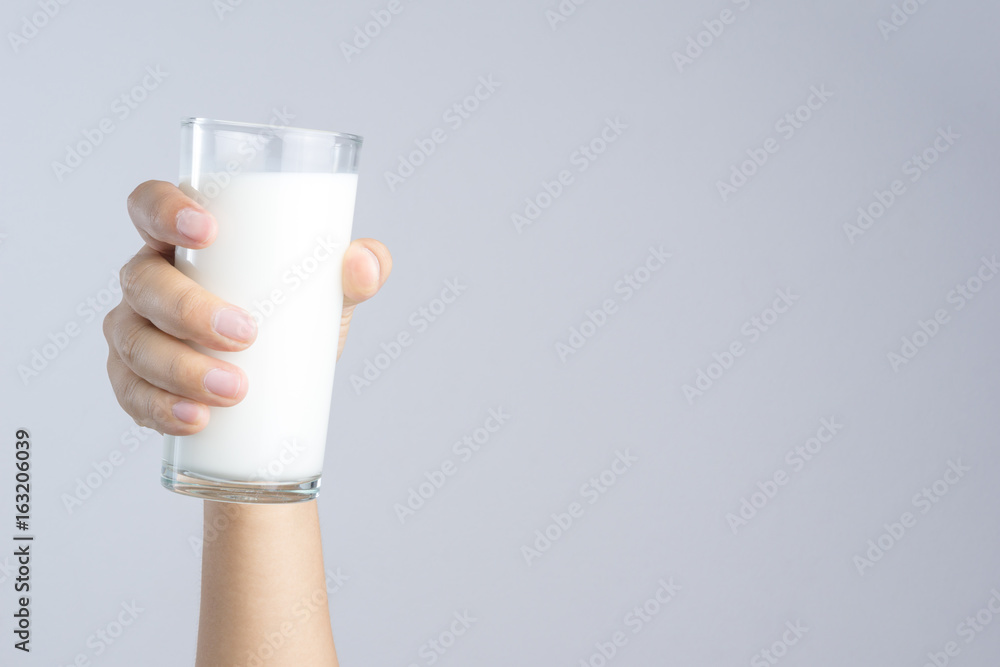 Hand holding a Glass of fresh milk Stock Photo | Adobe Stock
