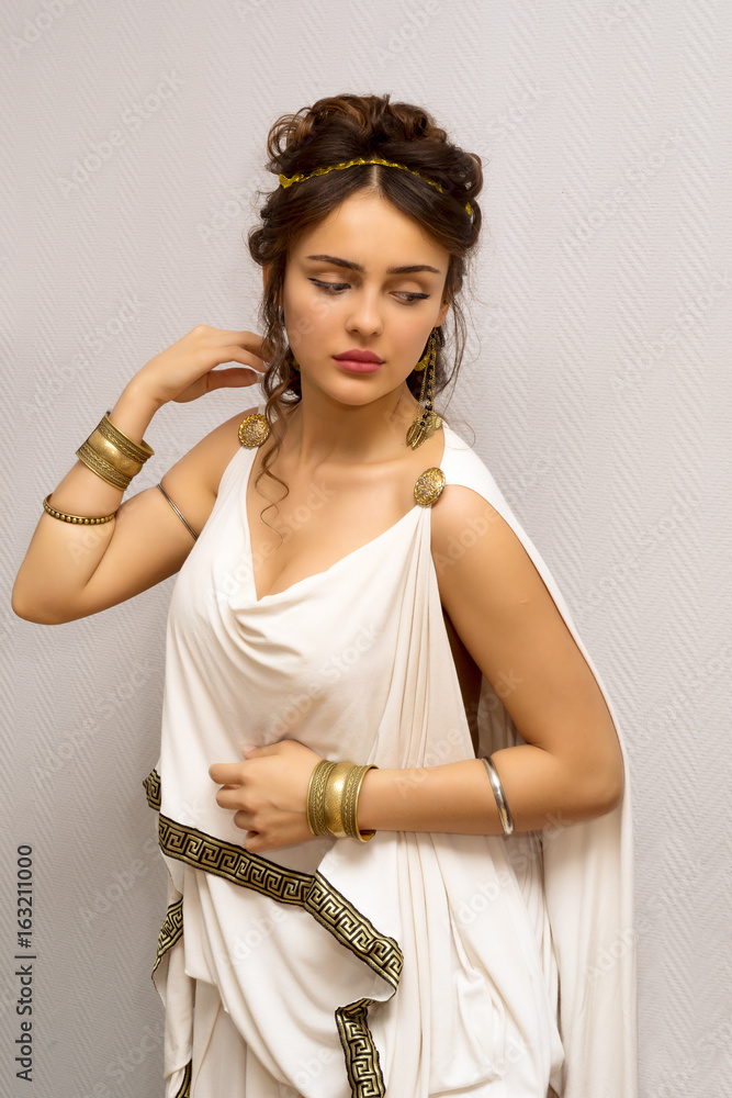 portrait of a beautiful graceful greek young woman in a traditional ...