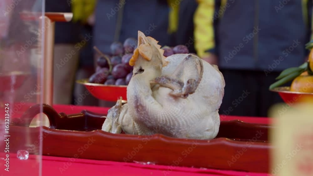 Offering of chicken to the deities in a Chinese temple in Taipei ...